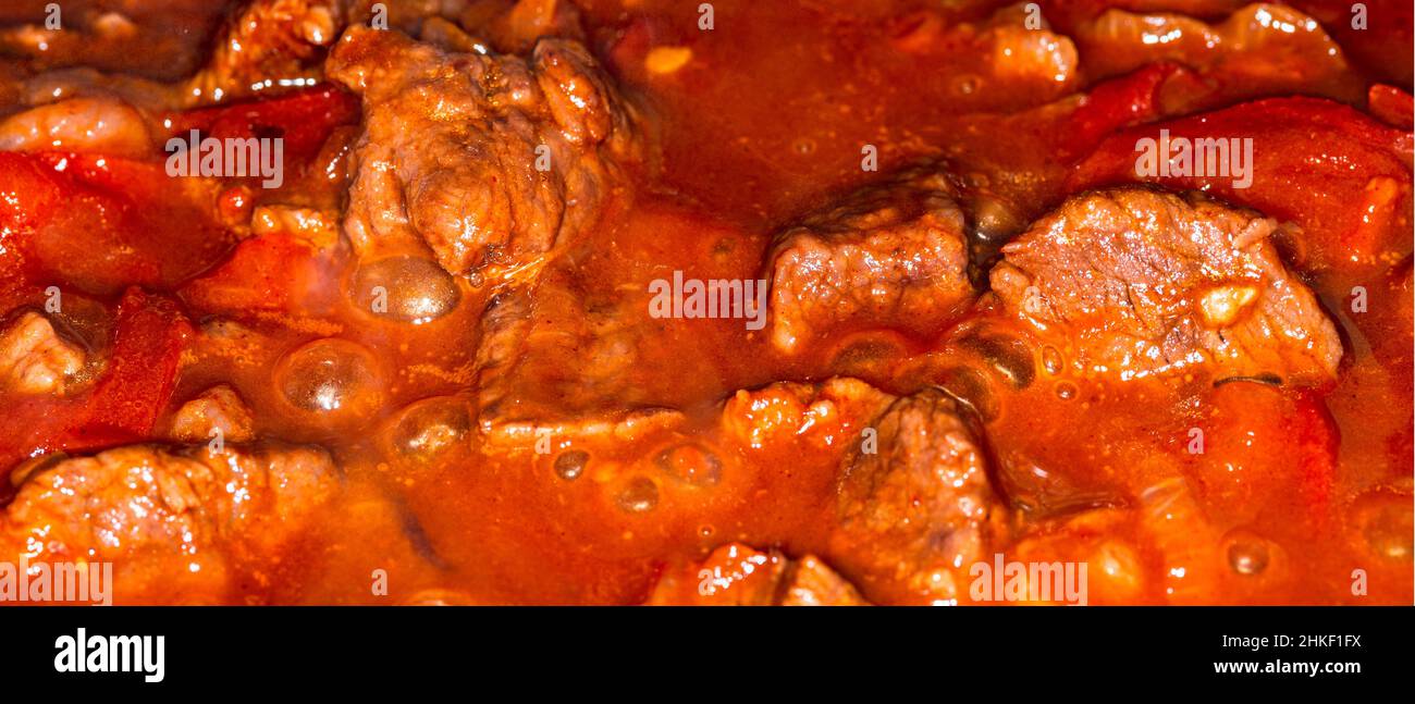 Traditional Hungarian goulash. Boiling beef stew with tomatoes and ...