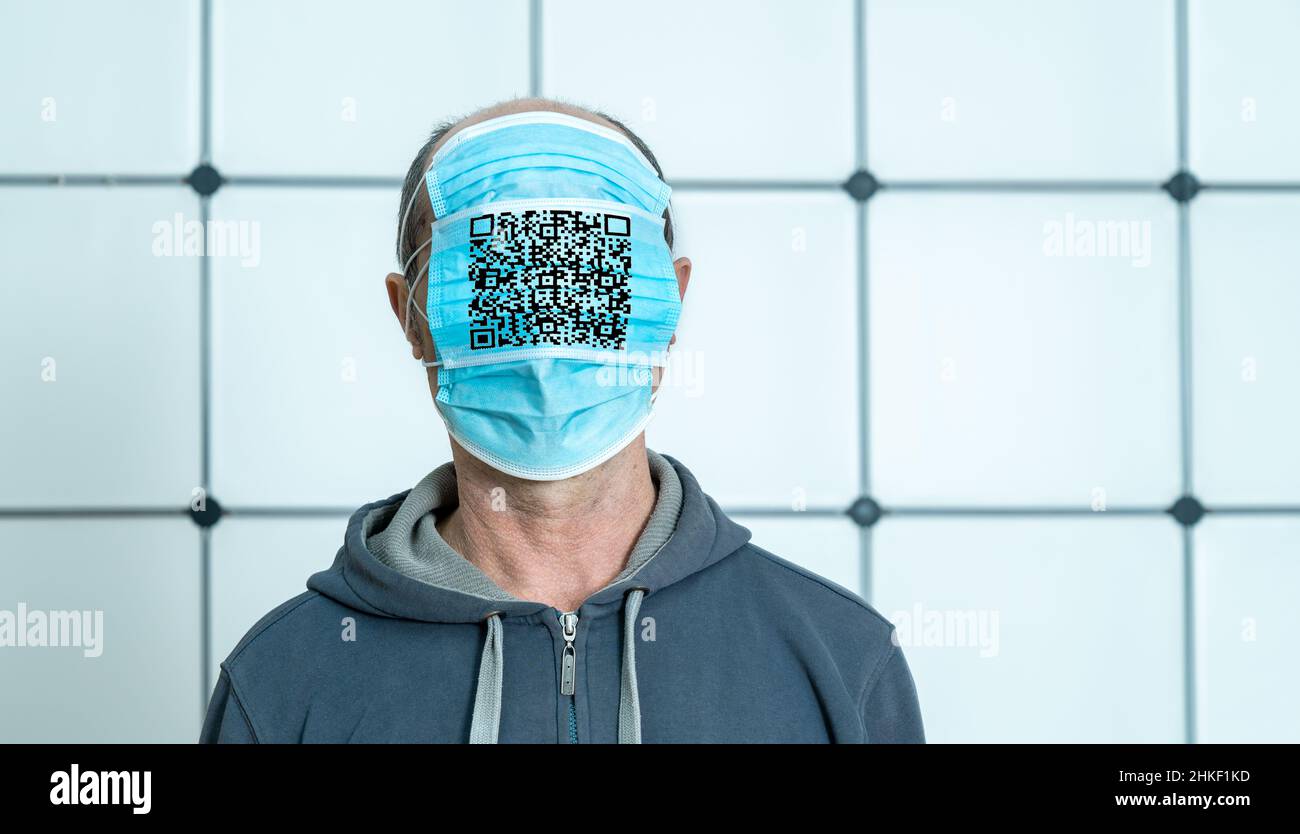 Man with face covered with medical masks and qr code. The concept of ...