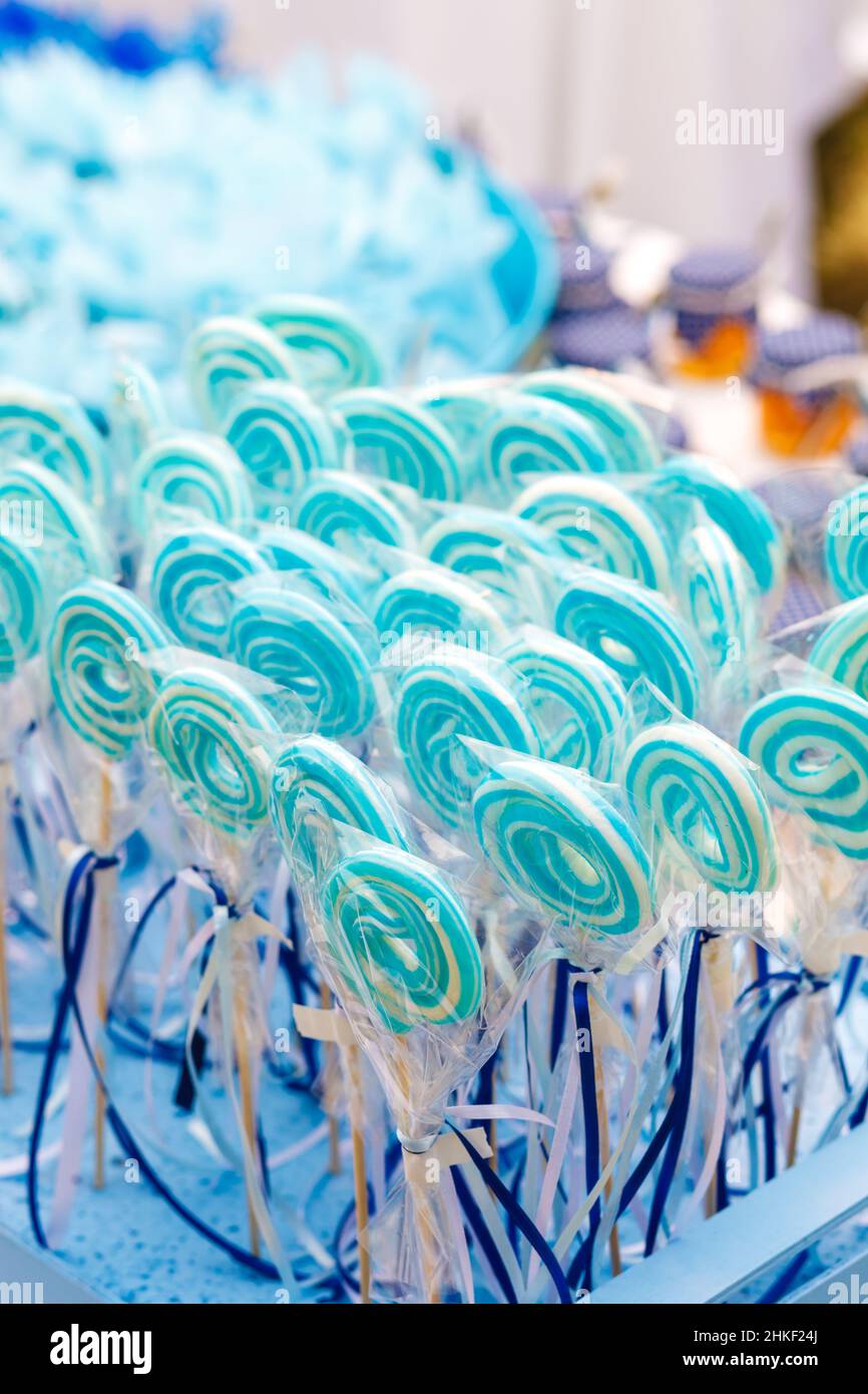 turquoise lollipops candies on the market showcase Stock Photo - Alamy