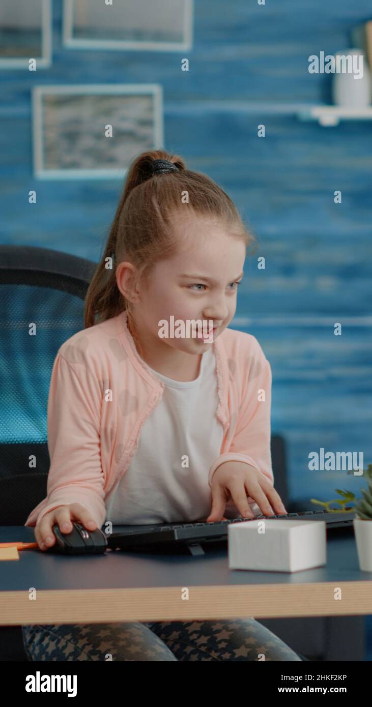 Frustrated child attending online classes on computer from home. Young ...