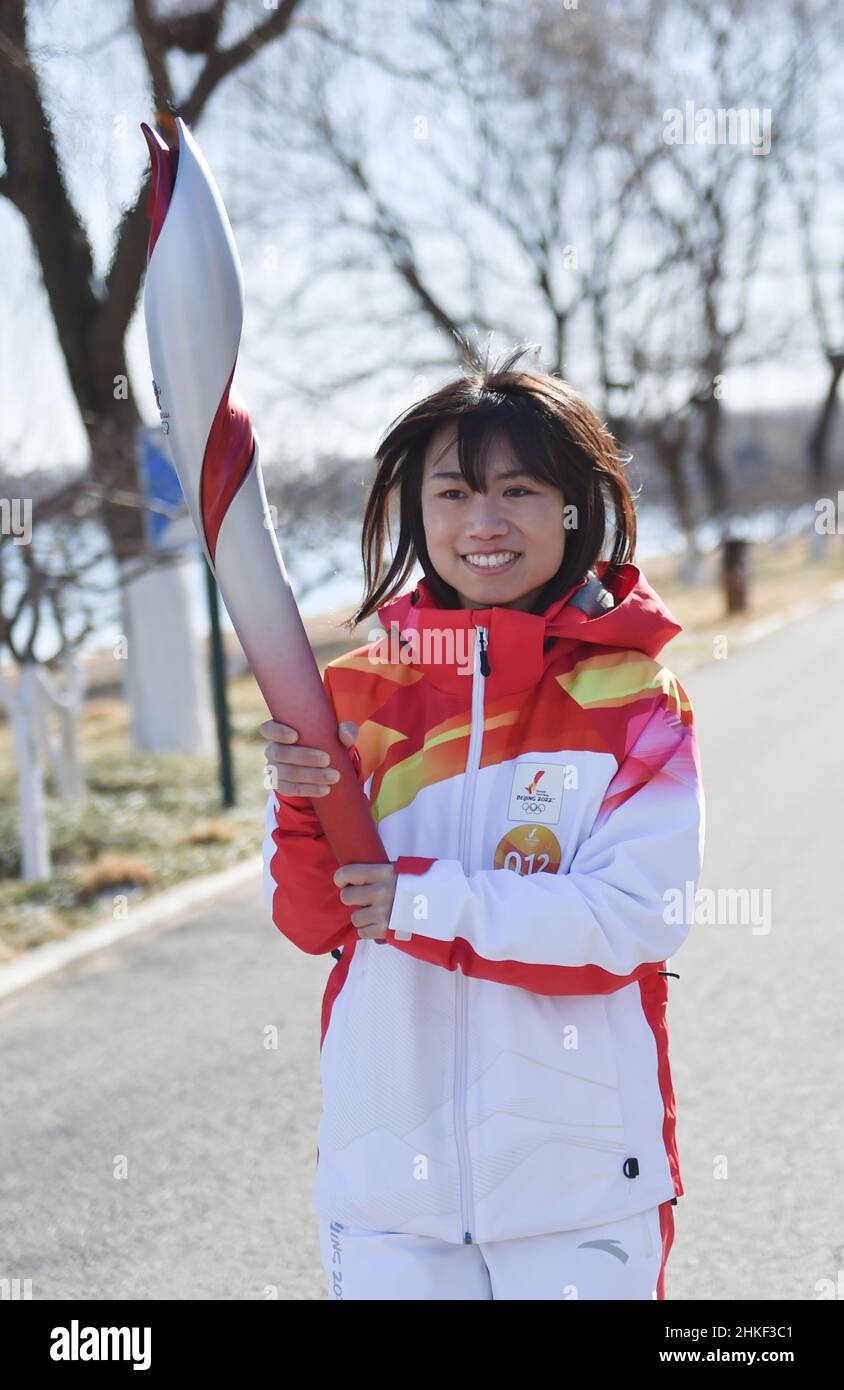 Beijing, China. 4th Feb, 2022. Torch bearer Ding Lu runs with the torch ...