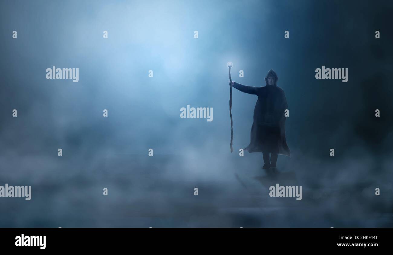Magician in cloak, cowl with magic stick standing in fog landscape ...