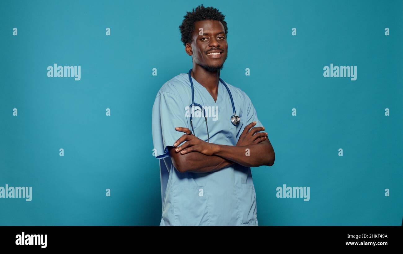 Confident nurse having crossed arms and looking at camera. Medical ...