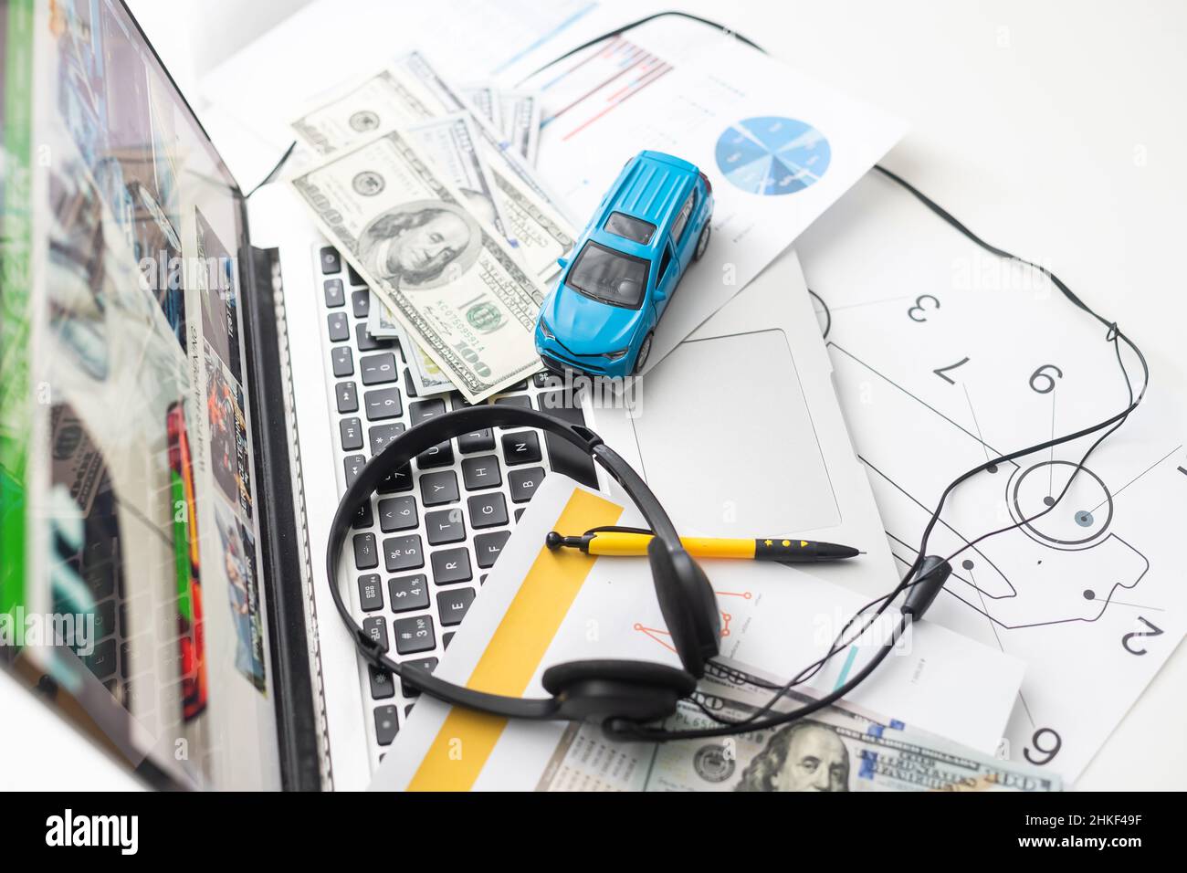 toy car with dollars is on the laptop. The programmer Stock Photo - Alamy
