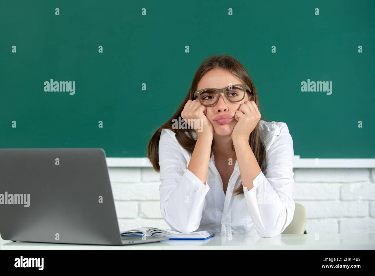 Student preparing exam and learning lessons in school classroom. Sad ...