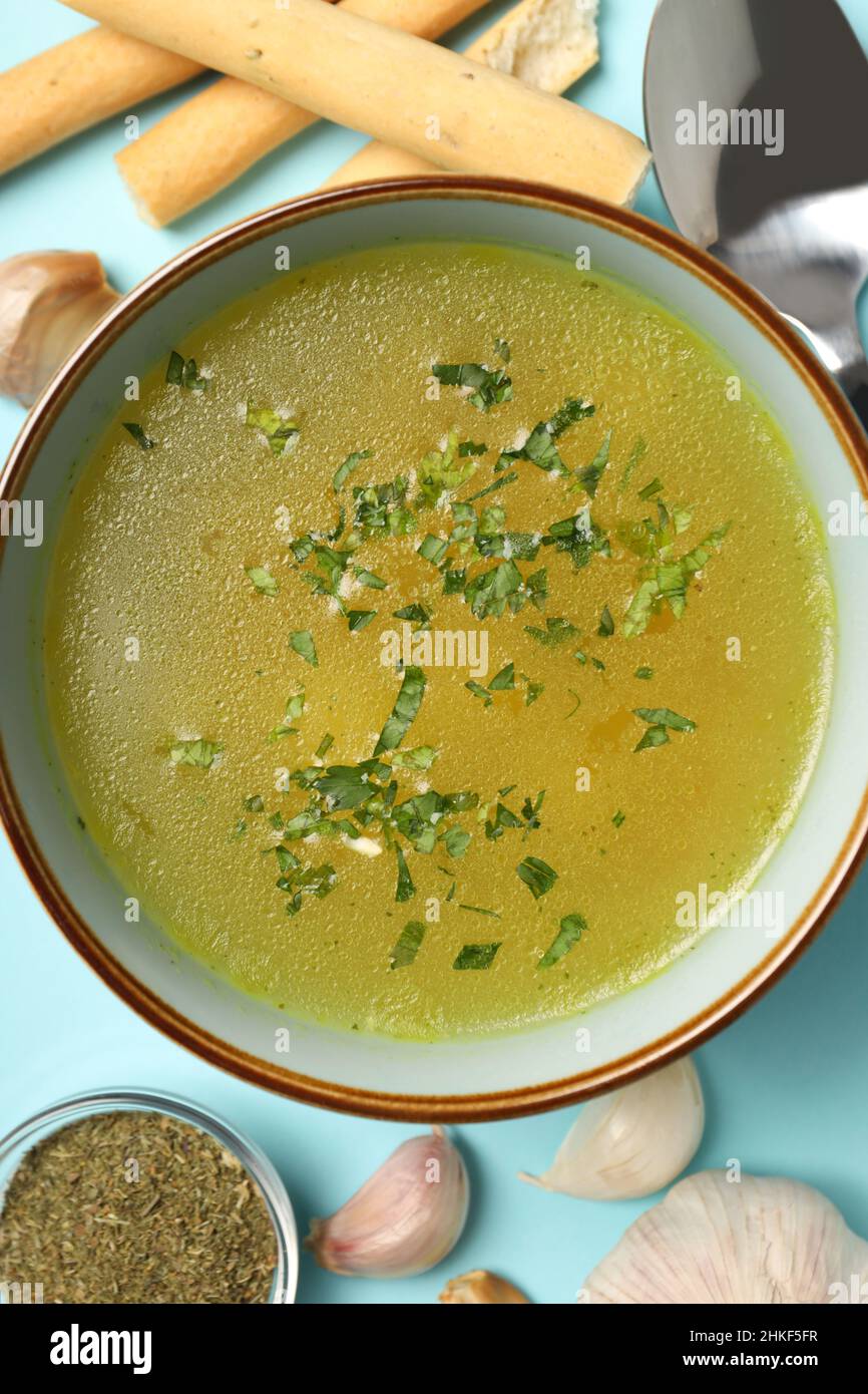 Concept of tasty food with broth on blue background Stock Photo - Alamy