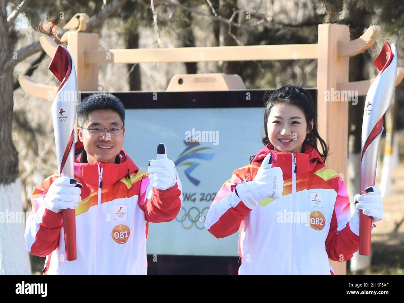 Beijing, China. 4th Feb, 2022. Torch bearers Wu Yadong (L) and Wang Xi attend the Beijing 2022 ...