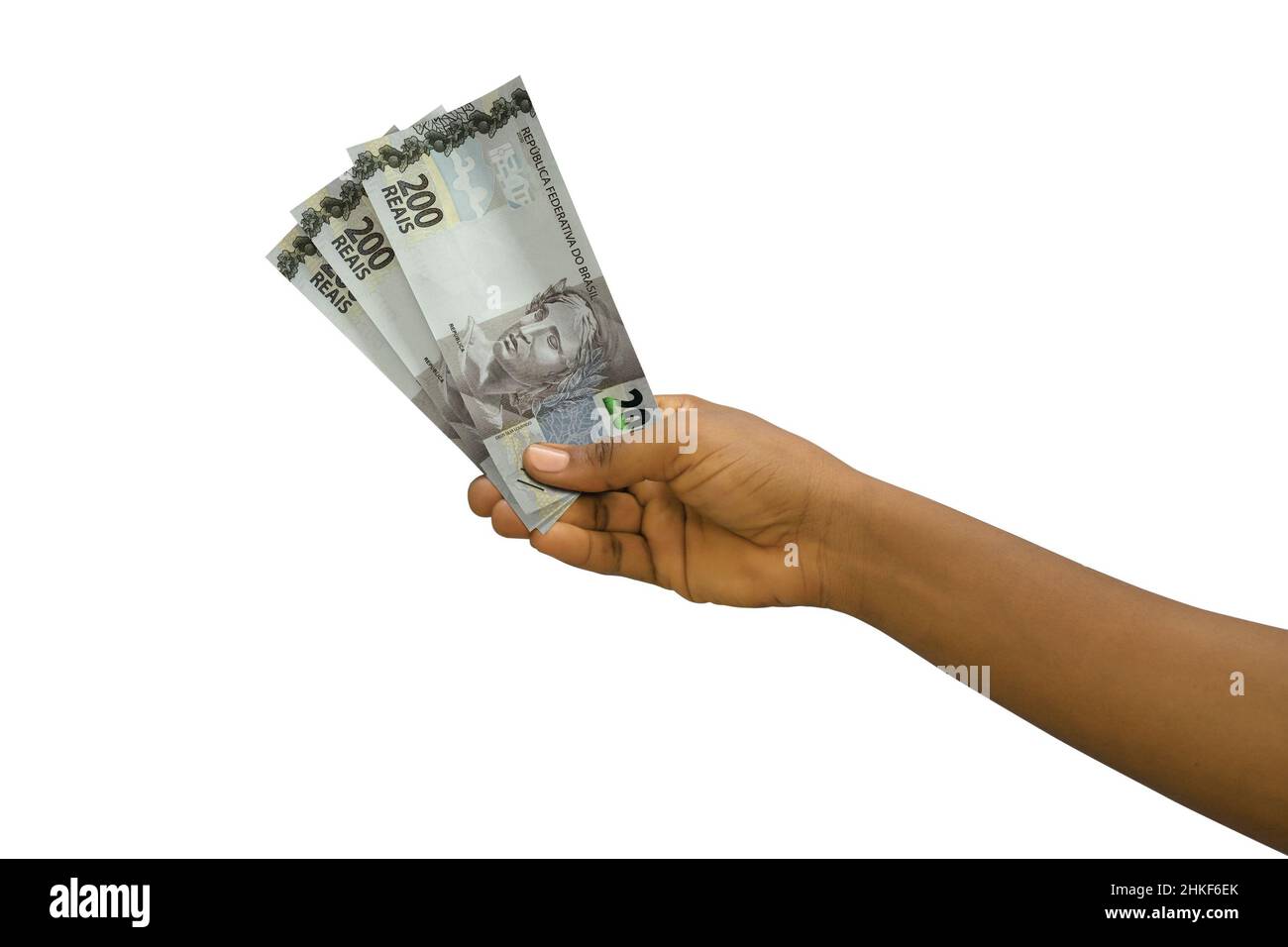 Fair hand holding 3D rendered Brazilian real notes isolated on white ...