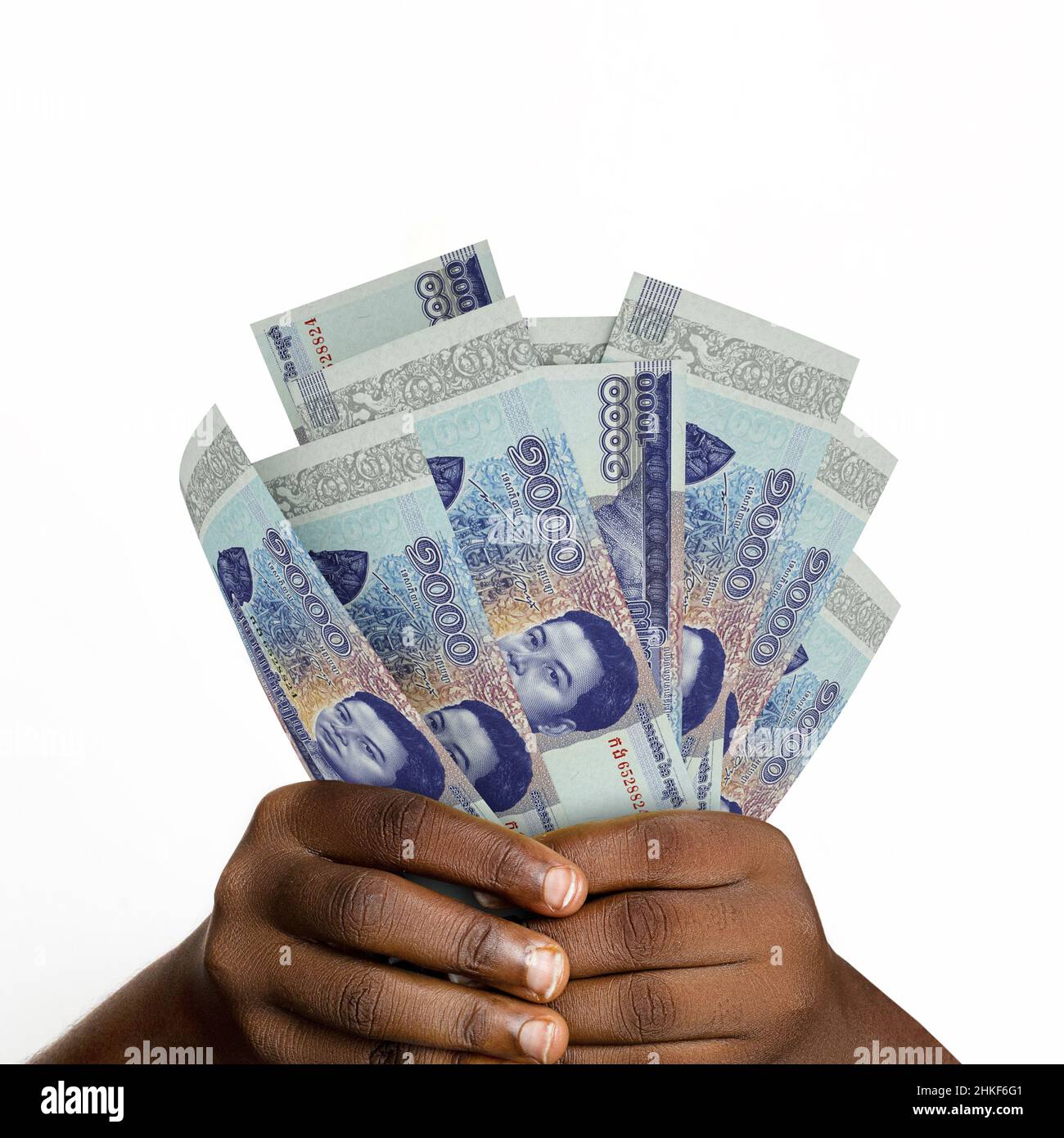 Black hands holding 3D rendered 1000 Cambodian riel notes. closeup of ...