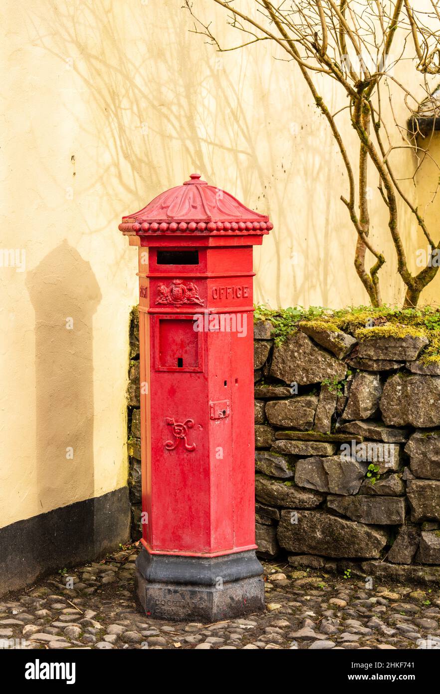 Red postal point for sending mail, old round postal box standing on the ...