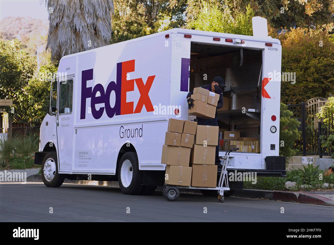FedEx driver loads his truck Stock Photo - Alamy