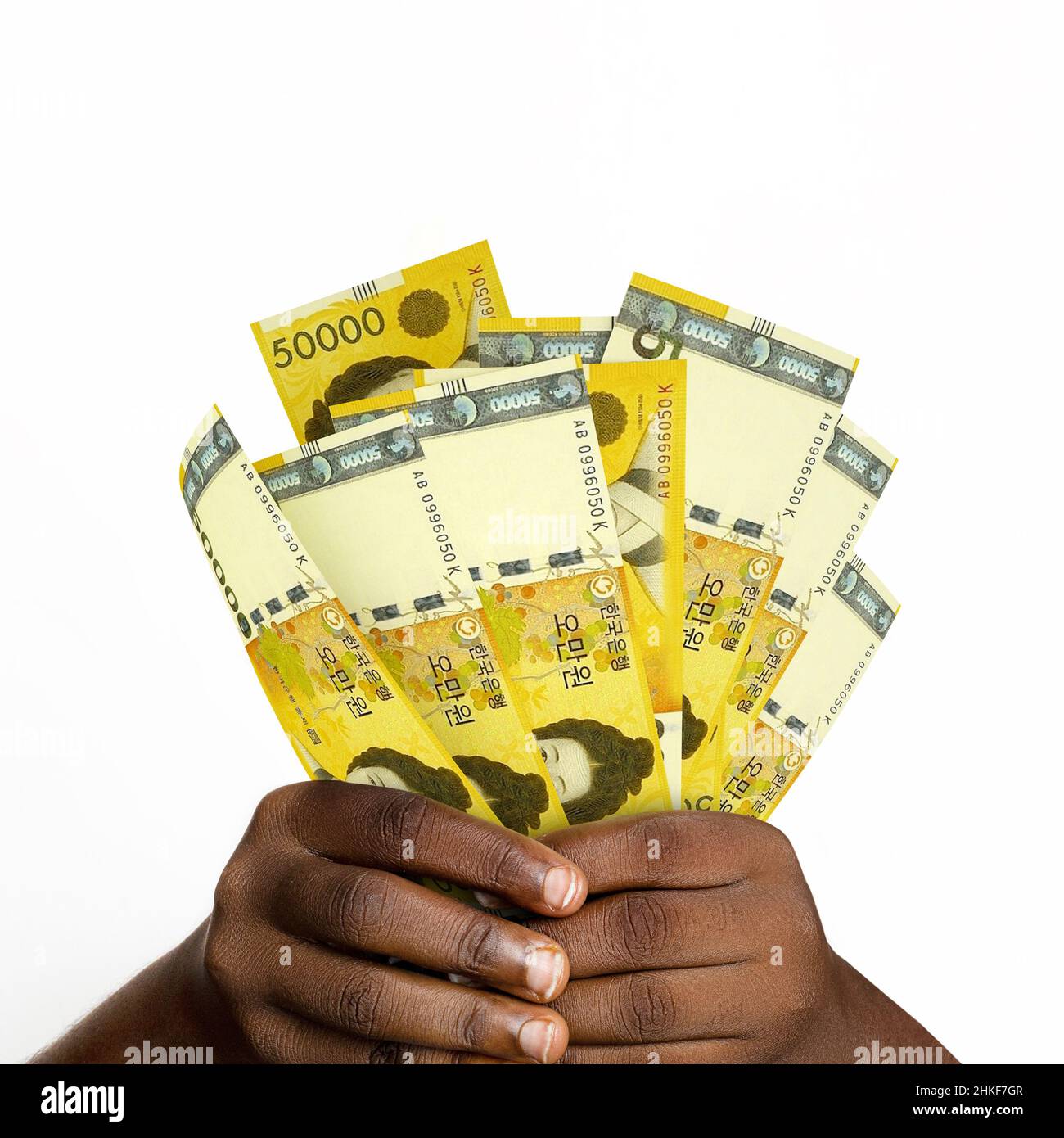 Black hands holding 3D rendered 50000 South Korean won notes. closeup ...
