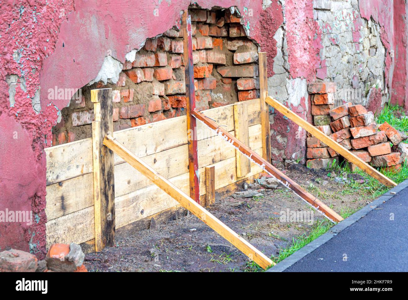 a fragment of an old brick wall is being repaired, which fell out due ...