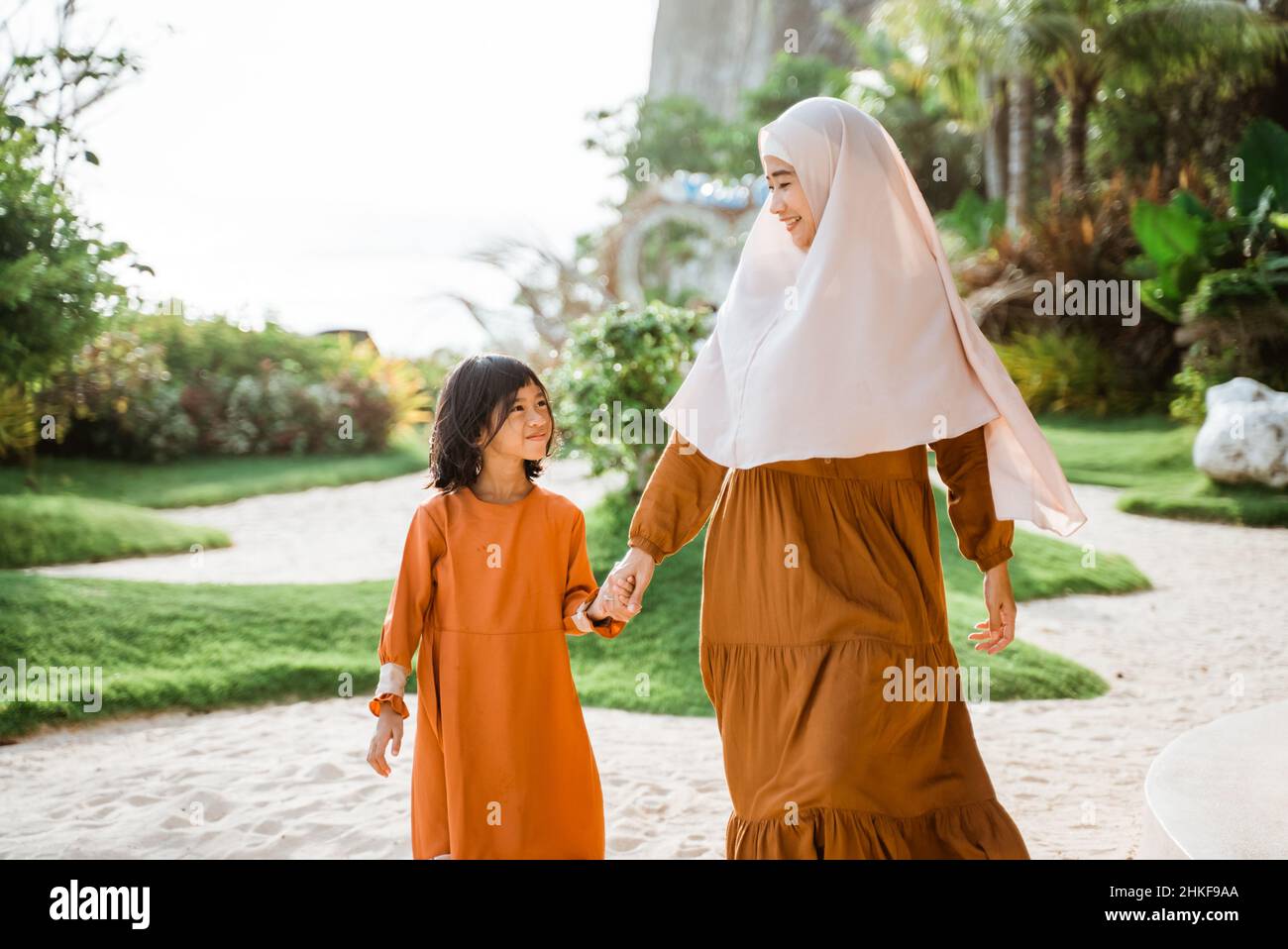 muslim mother and daughter walking and hold hand together Stock Photo ...