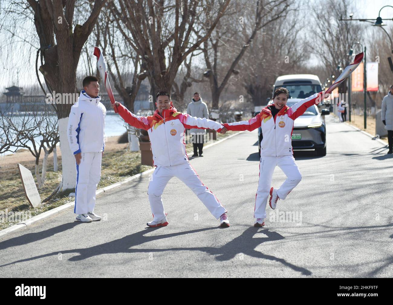 Beijing, China. 4th Feb, 2022. Torch bearers Sun Youjun (L) and Pu Tianfan attend the Beijing ...