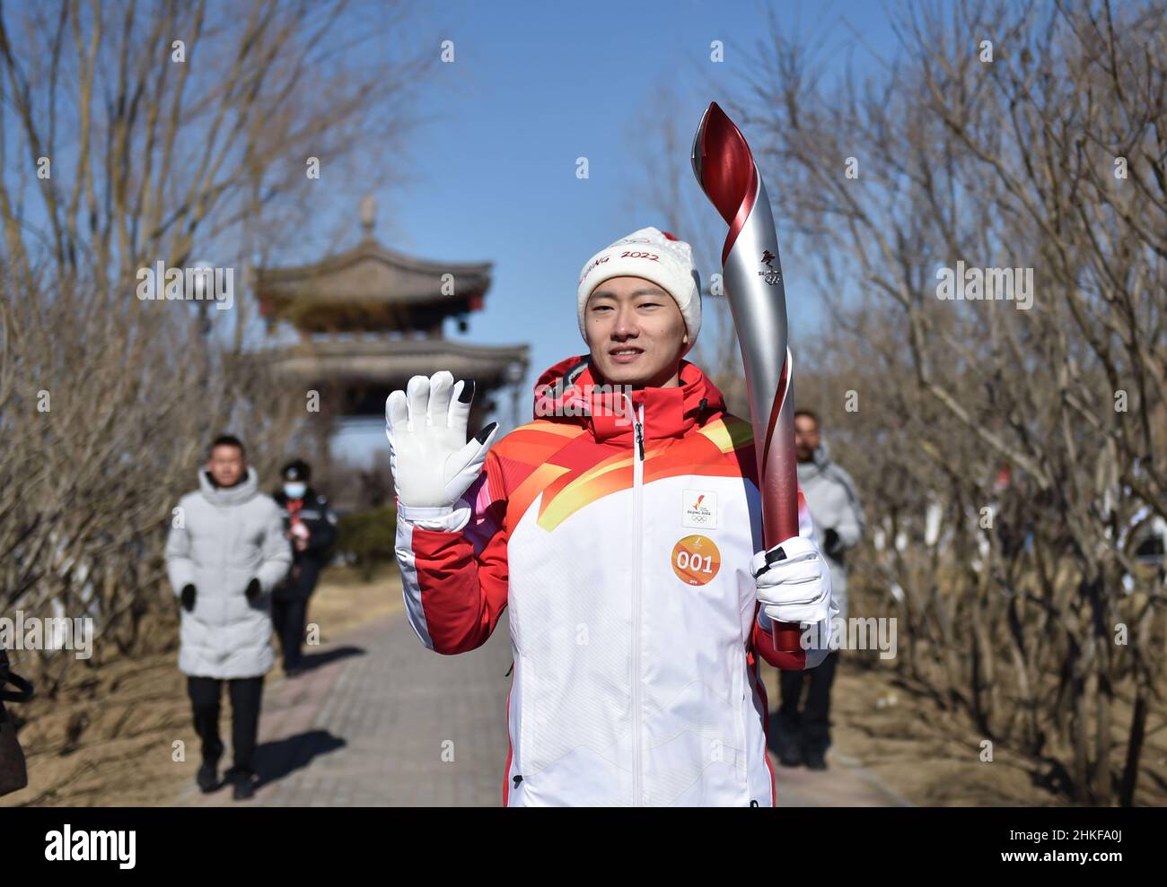 Beijing, China. 4th Feb, 2022. Torch bearer Zhang Nan runs with the torch during the Beijing ...