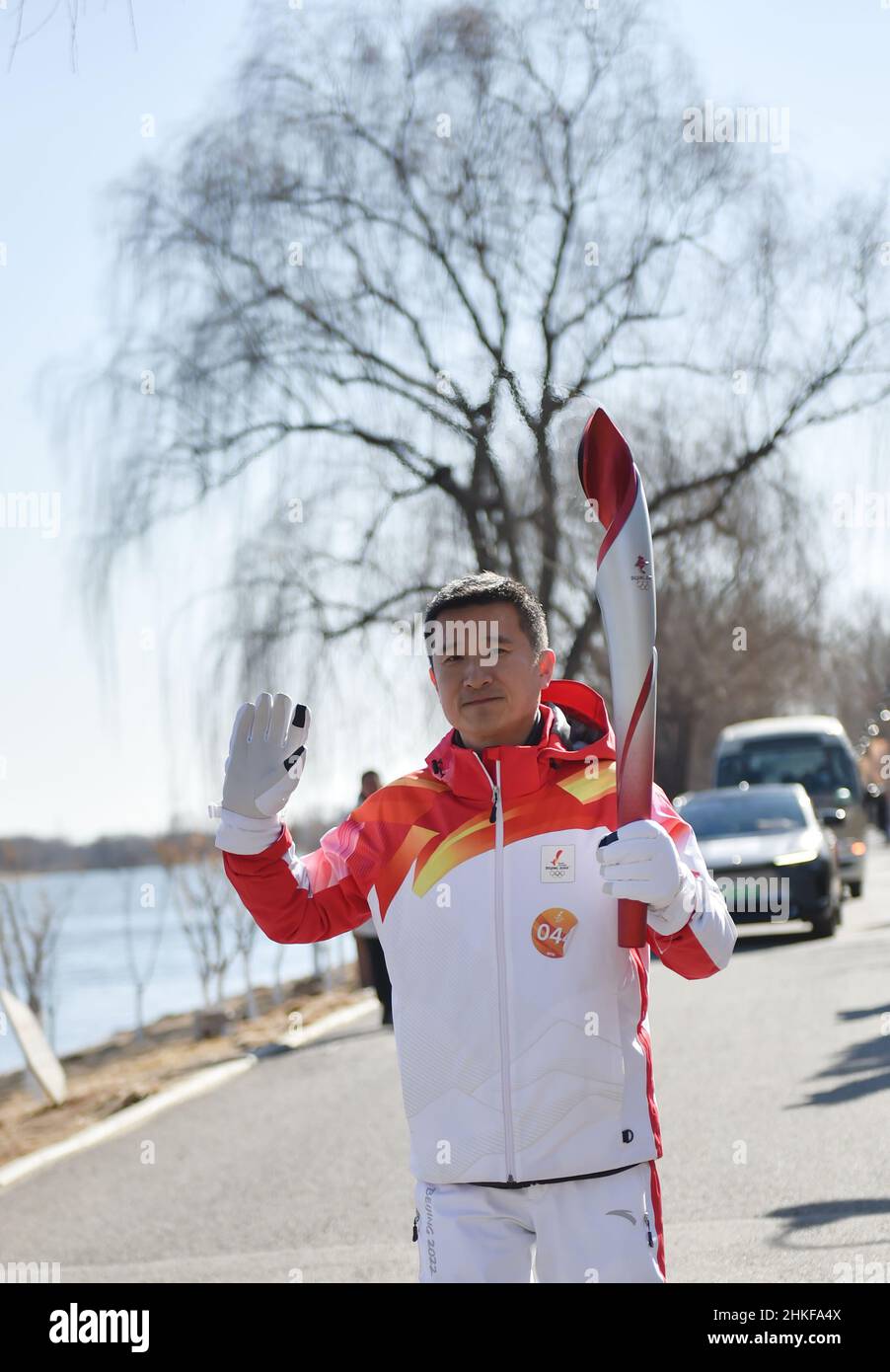 Beijing, China. 4th Feb, 2022. Torch bearer Xu Zheng runs with the torch during the Beijing 2022 ...