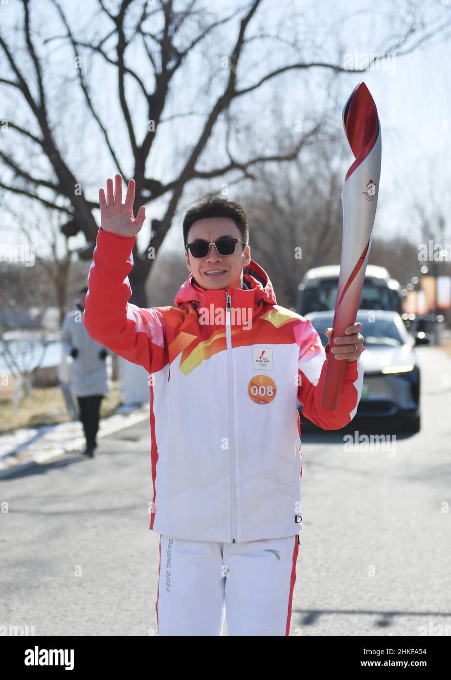 Beijing, China. 4th Feb, 2022. Torch bearer Hou Kun runs with the torch during the Beijing 2022 ...