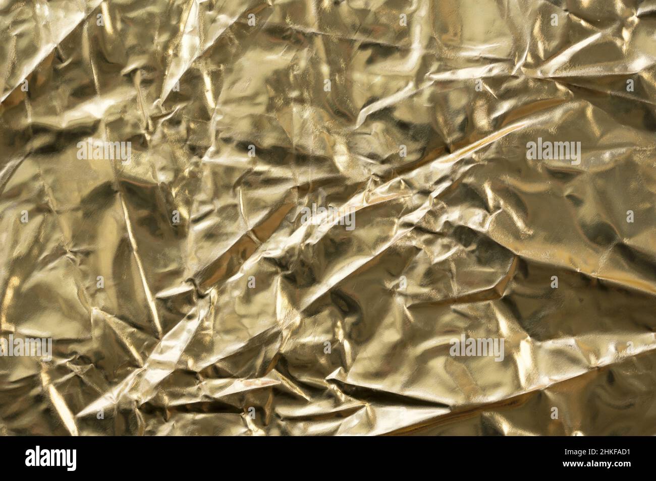 Shiny crumpled gold foil texture background. Pattern of golden wrapping ...