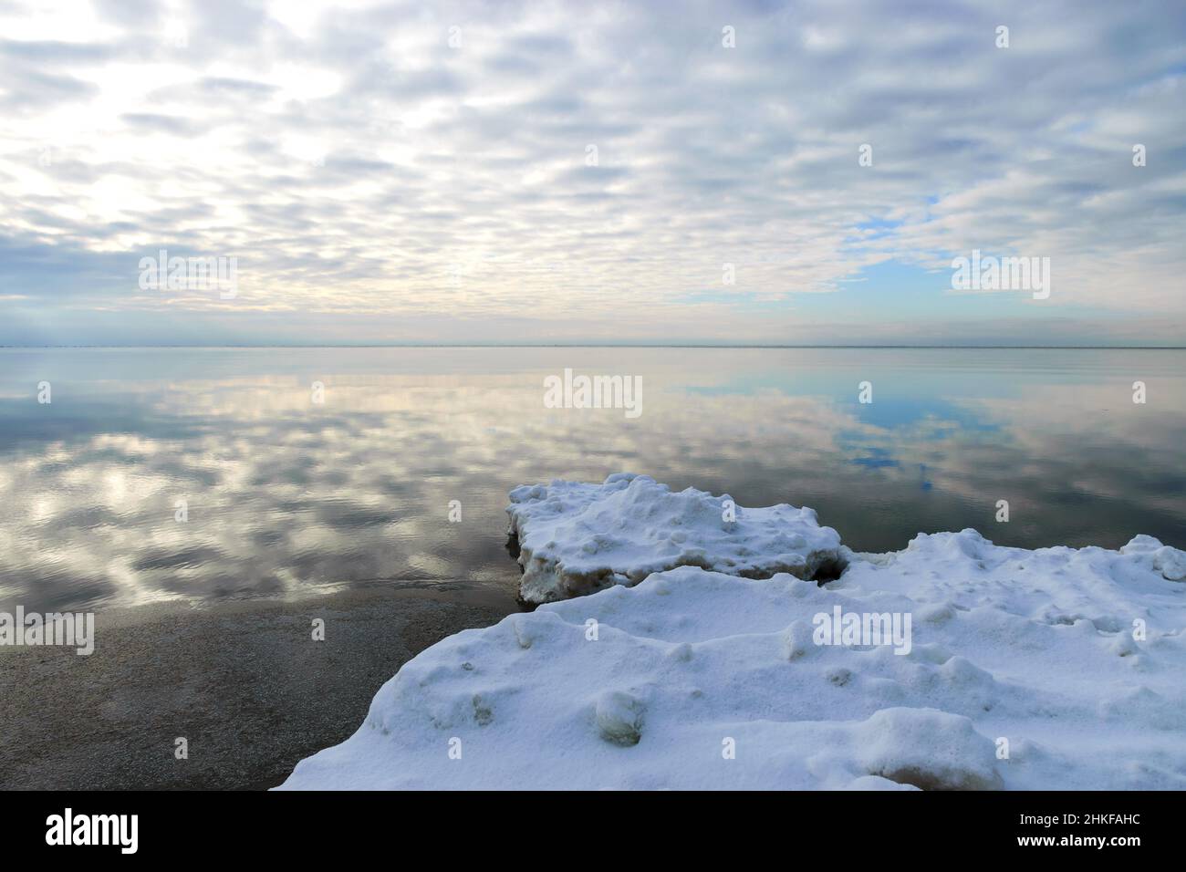 Winter seascape, slow freezing sea, glorious skies, white pieces of ice ...