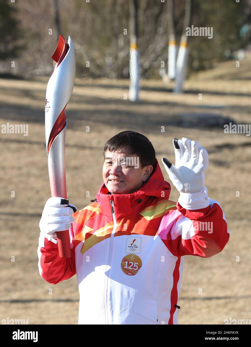 Beijing, China. 4th Feb, 2022. Torch bearer Zhang Yuntao runs with the ...