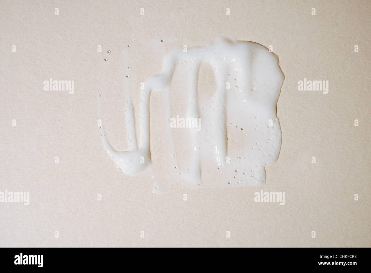 White cream swatch smudge with beads on beige background. Special self ...