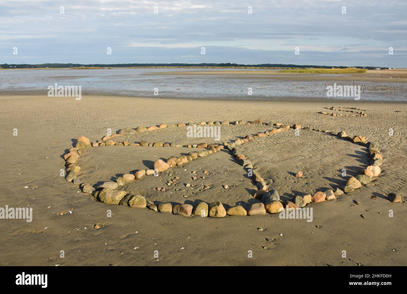 Stunning design of a peace symbol on a beach made of rocks Stock Photo ...
