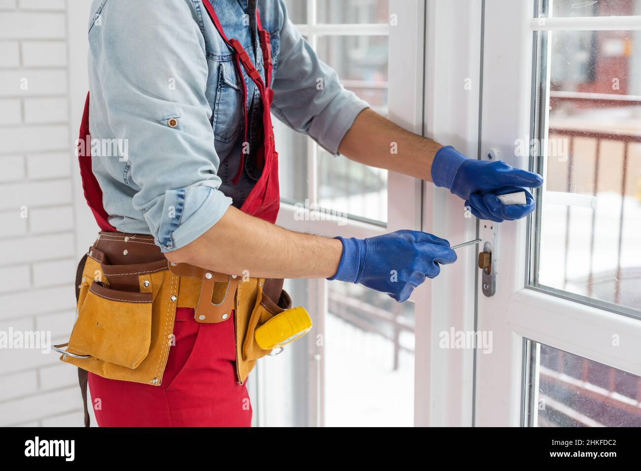Construction worker installing window in house. Handyman fixing the ...