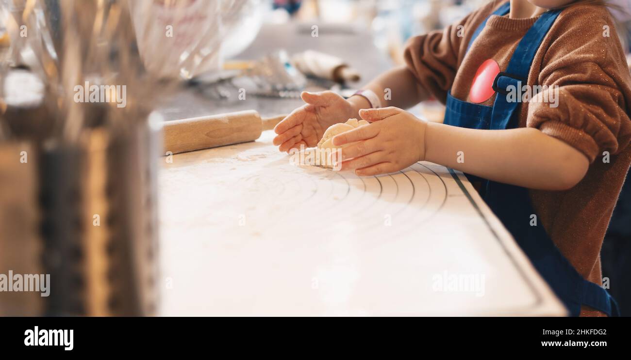 Cooking baking workshop class for school kids. Cute girl playful ...