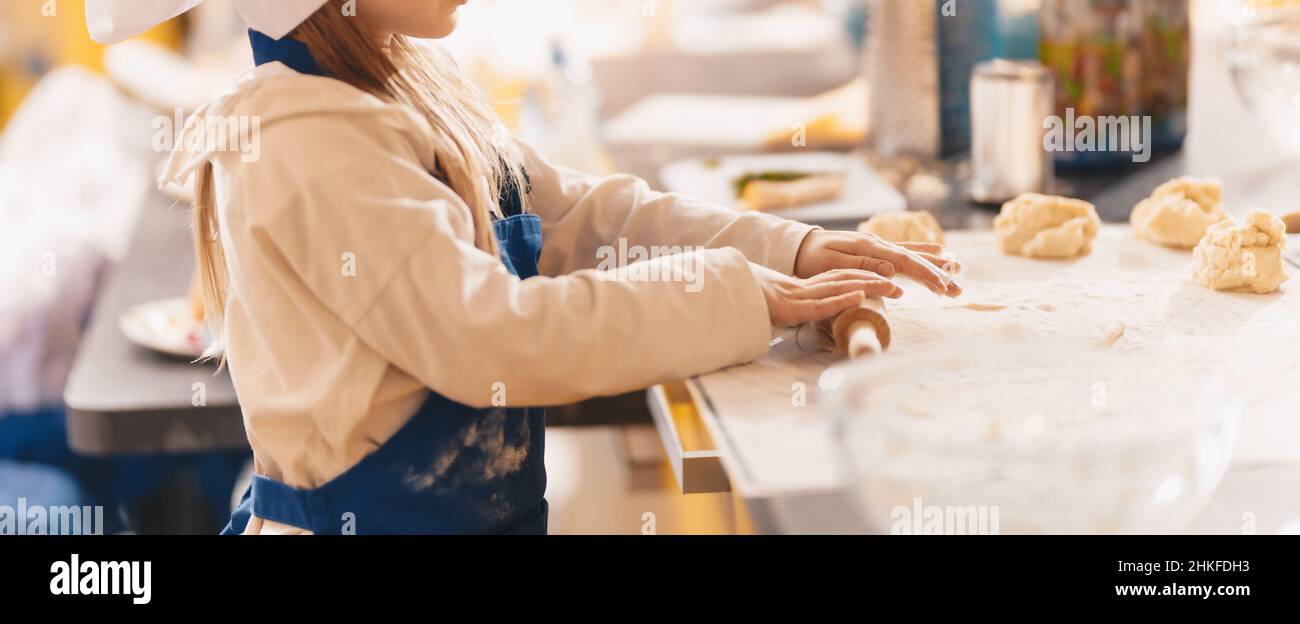 Cooking baking workshop class for school kids. Cute girl playful ...