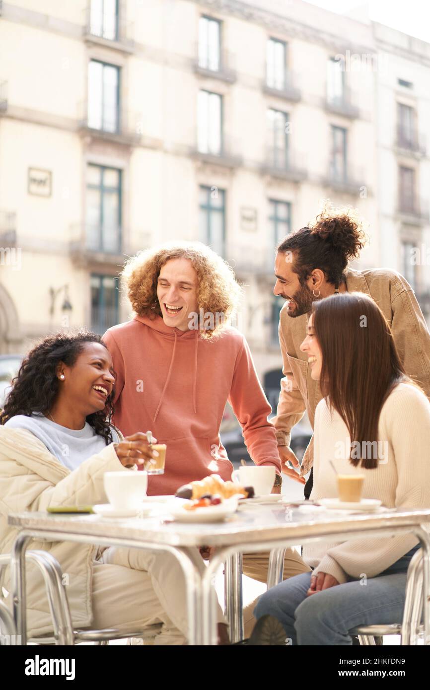 Vertical photo of Friends group toasting latte at coffee bar terrace ...
