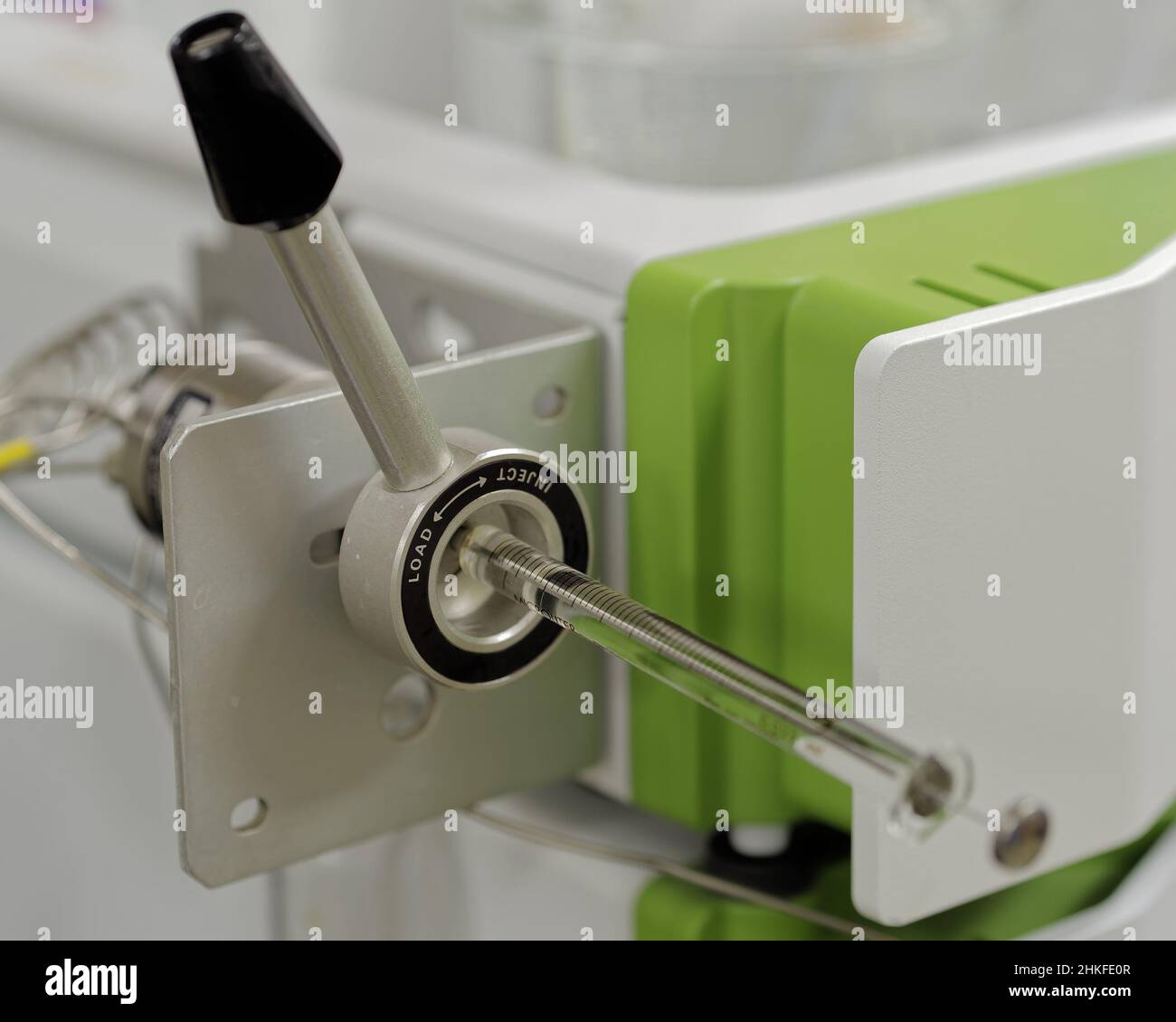 A syringe loaded into a sample injector Stock Photo - Alamy