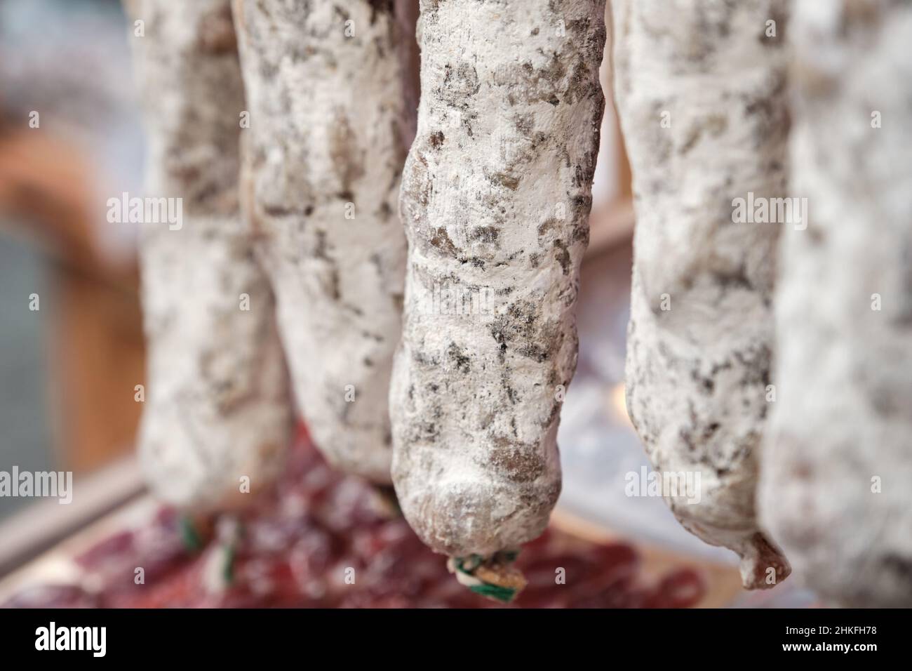 Close up of hanging salami sausages in a street market. Shallow Depth of Field Stock Photo - Alamy