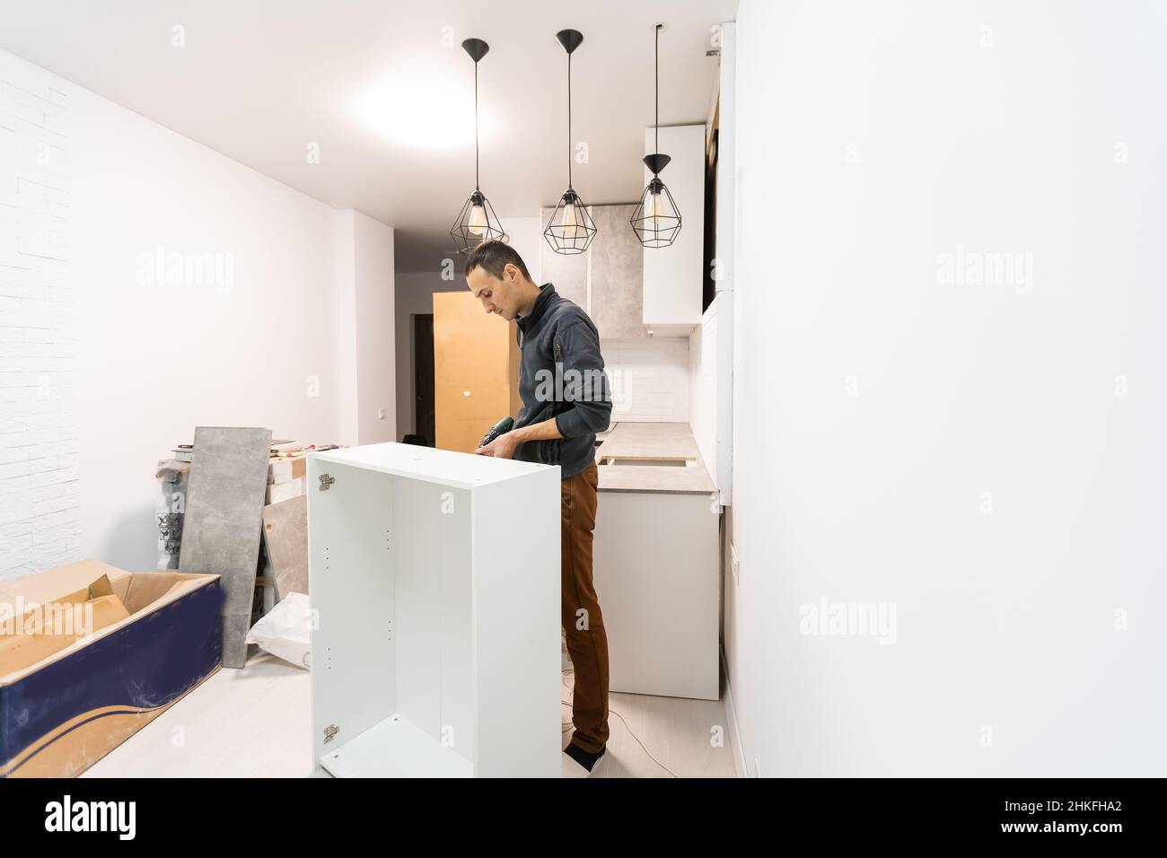 Worker installing new countertop in modern kitchen Stock Photo - Alamy
