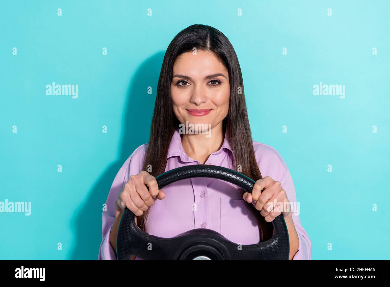 Photo of brunette optimistic young lady drive auto wear purple shirt ...