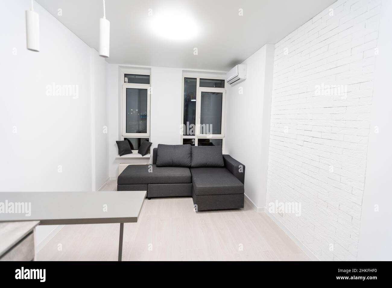 Modern studio flat with small kitchen, sofa Stock Photo - Alamy