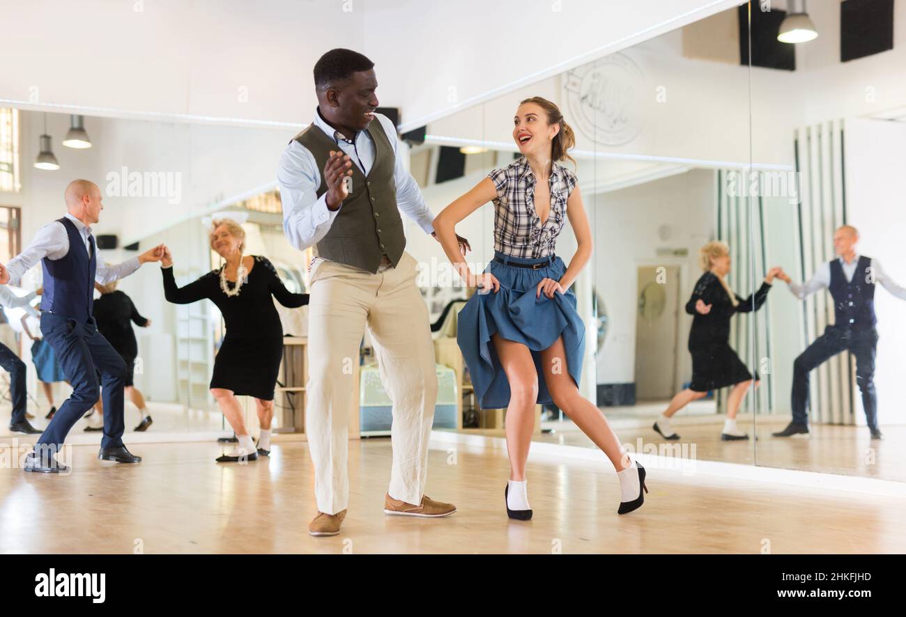 Woman with african man practising charleston dancing Stock Photo - Alamy