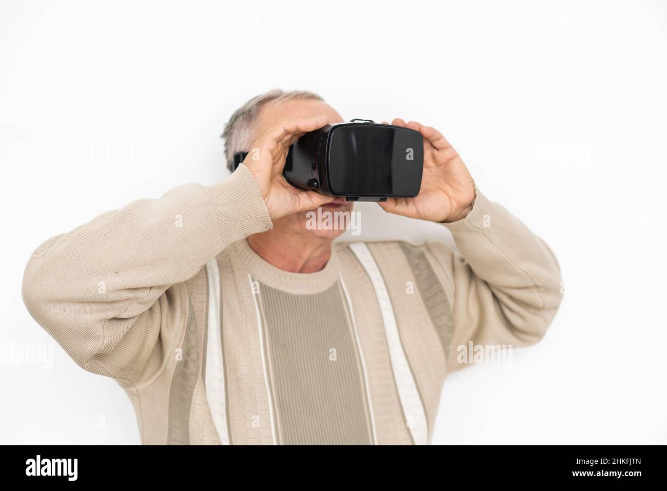 Senior man playing video game on white background Stock Photo - Alamy