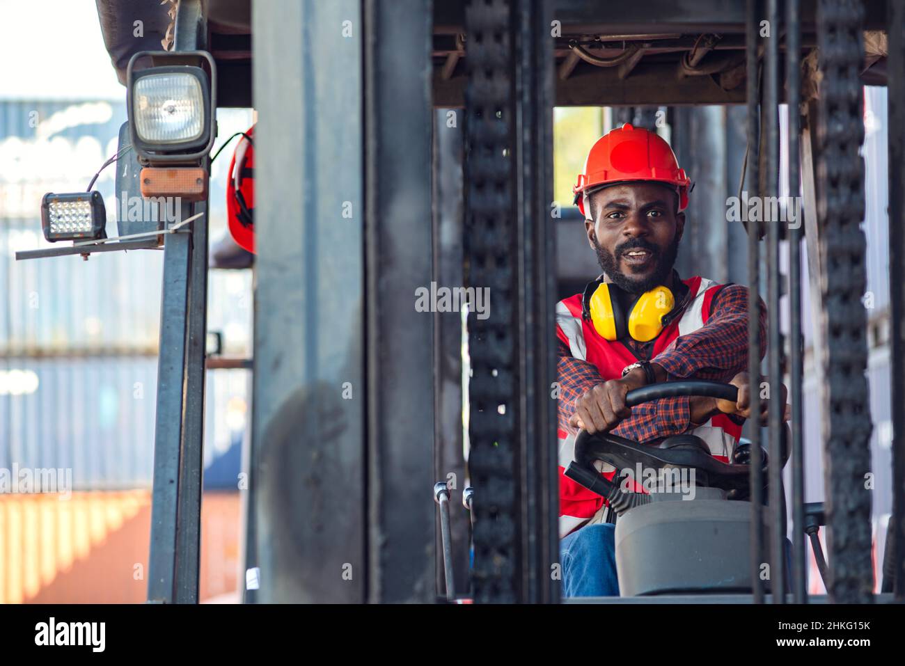 Male worker in uniform and helmet driving and operating on diesel ...