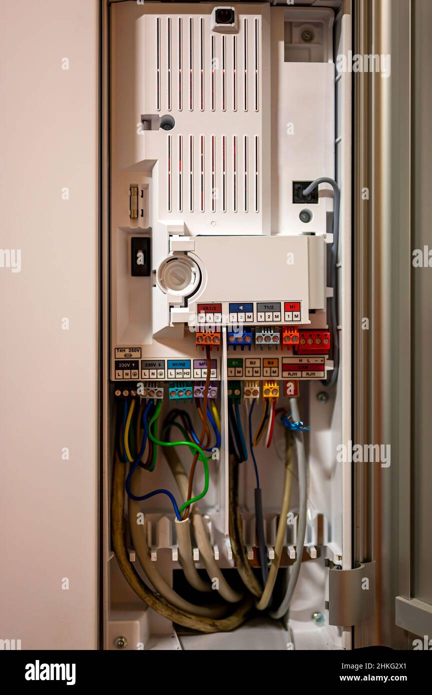 Open control box of a modern heating system with visible wiring. The ...