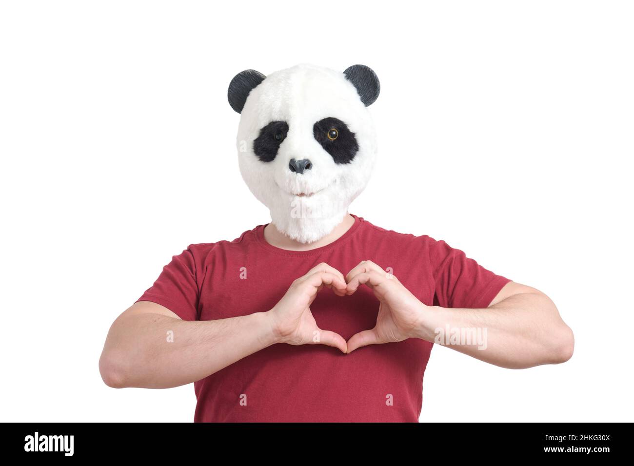 Man wearing a panda mask head showing a heart shape with hands ...