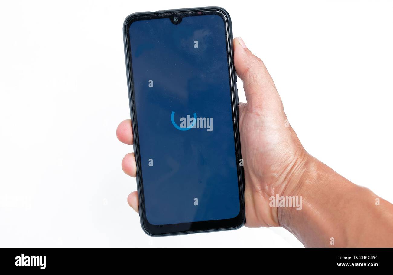 Display loading on the smartphone screen. Hand holding handphone in ...