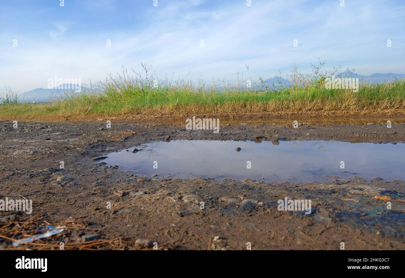 Puddles on the road, Puddles after the rain, Mud roads are damaged and ...