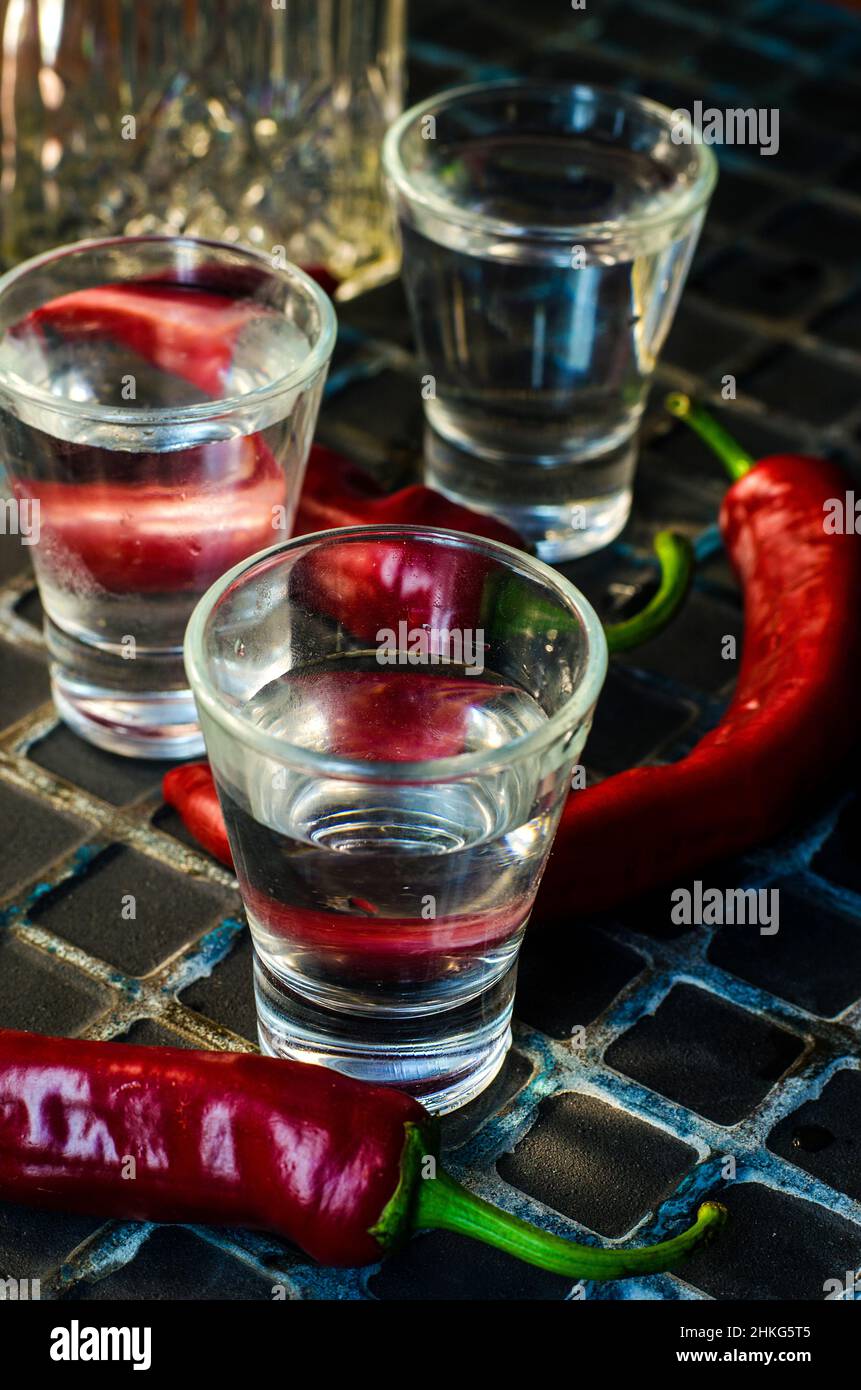 glass of vodka with hot peppers on dark background Stock Photo - Alamy