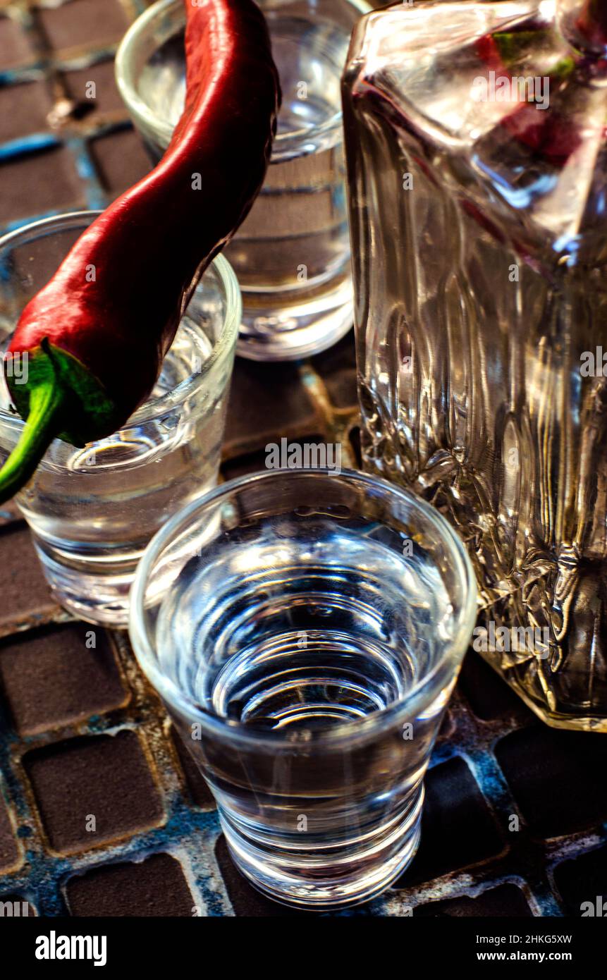 glass of vodka with hot peppers on dark background Stock Photo - Alamy