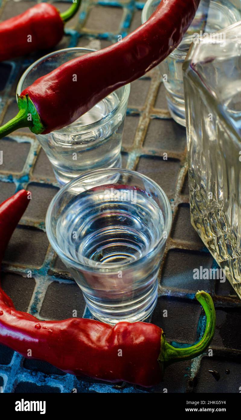 glass of vodka with hot peppers on dark background Stock Photo - Alamy