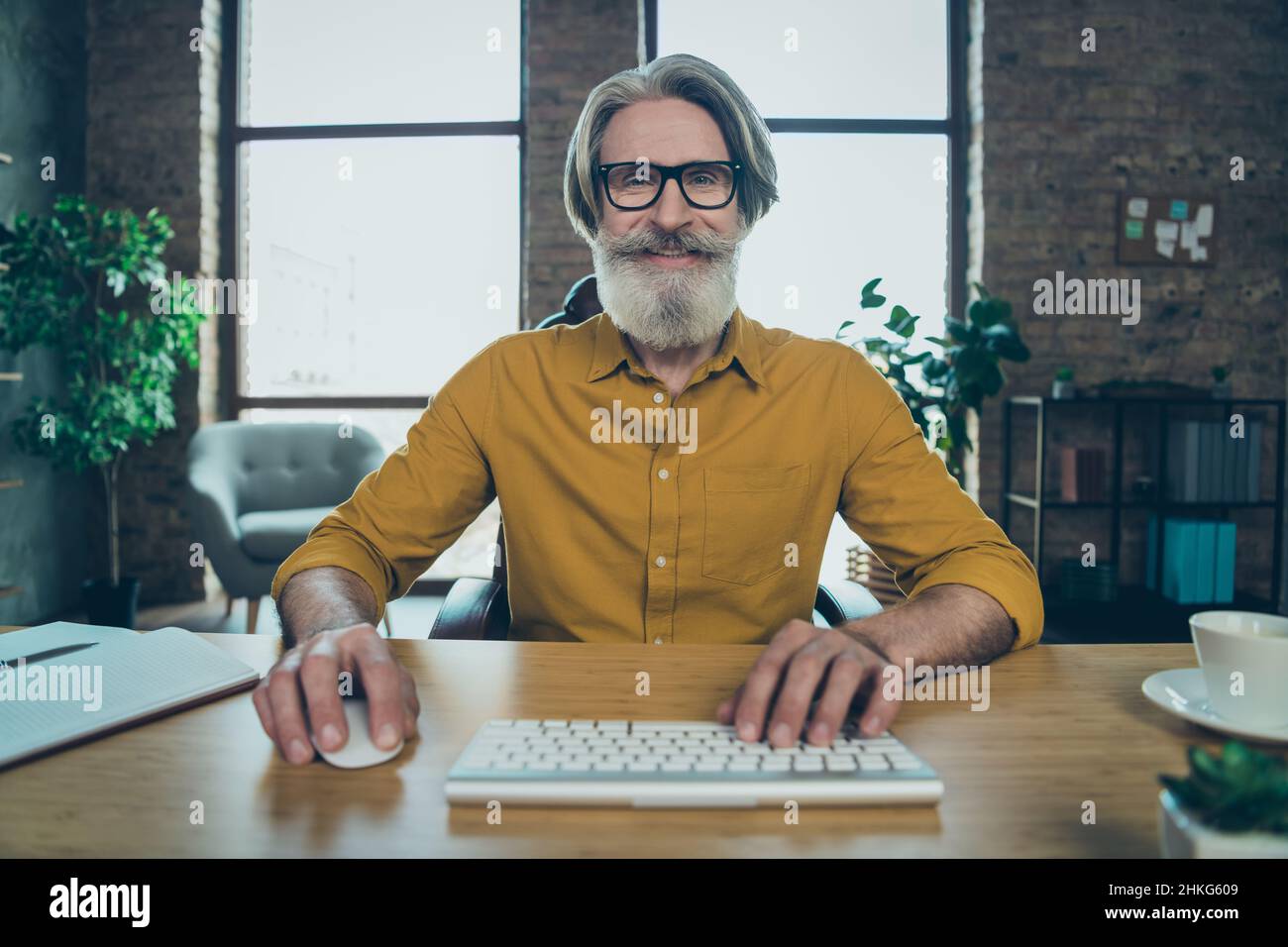 Photo of busy senior man wear yellow shirt glasses chatting modern ...