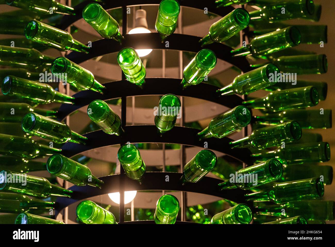 A chandelier made of beer bottles. Empty bottles under a bright light ...