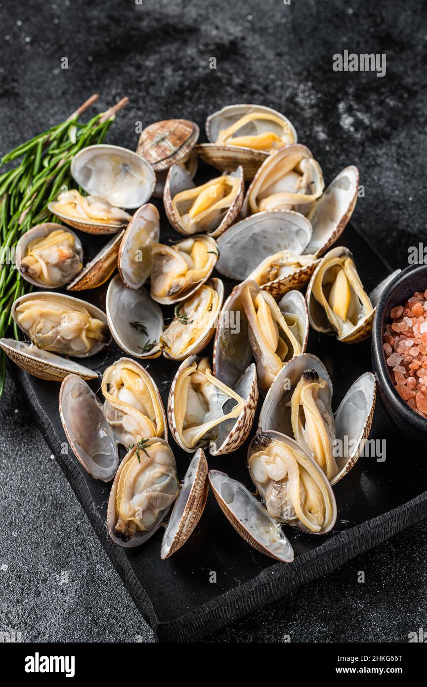 Steamed shellfish Clams with garlic and herbs. Black background. Top ...