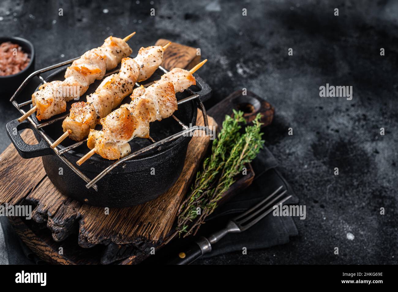 Grilled Chicken skewers souvlaki, poultry meat shish kebab. Black background. Top view. Copy ...